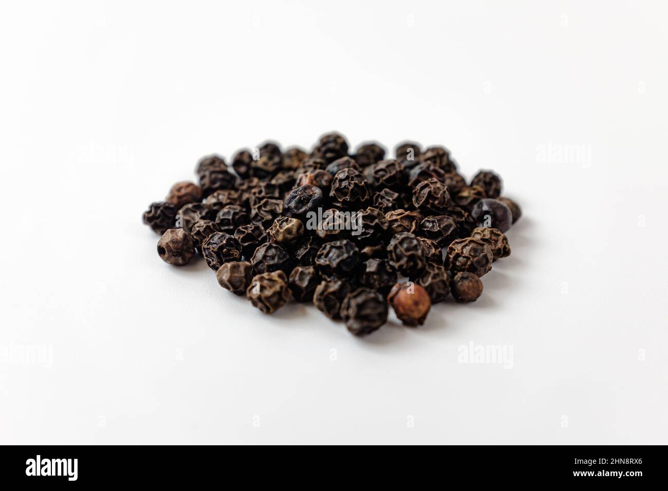 whole pepper on a white background Stock Photo - Alamy