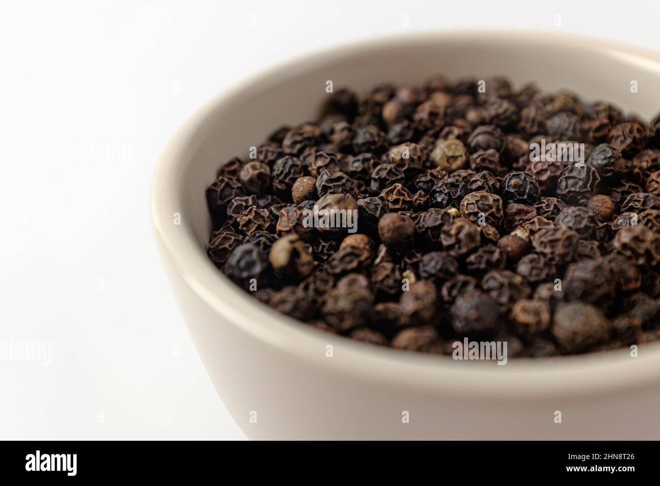whole pepper on a white background Stock Photo - Alamy