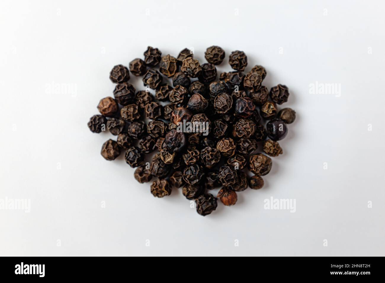 whole pepper on a white background Stock Photo - Alamy