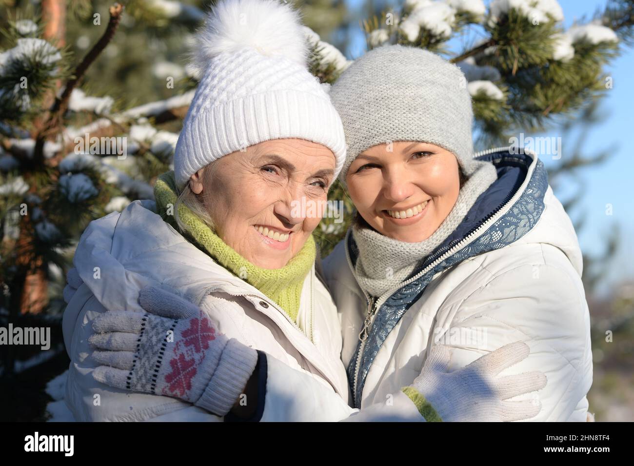 Happy woman with mother in winter clothes posing outdoors Stock Photo ...