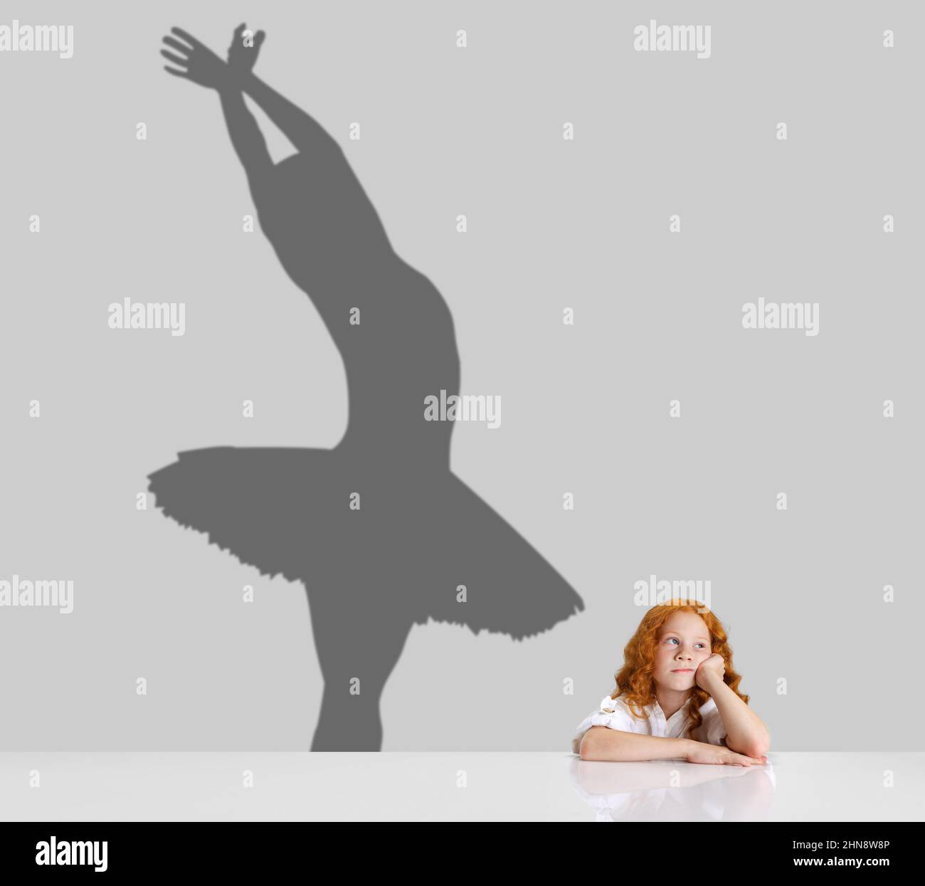 Cute child, little girl dreaming about future of famous ballet dancer ...