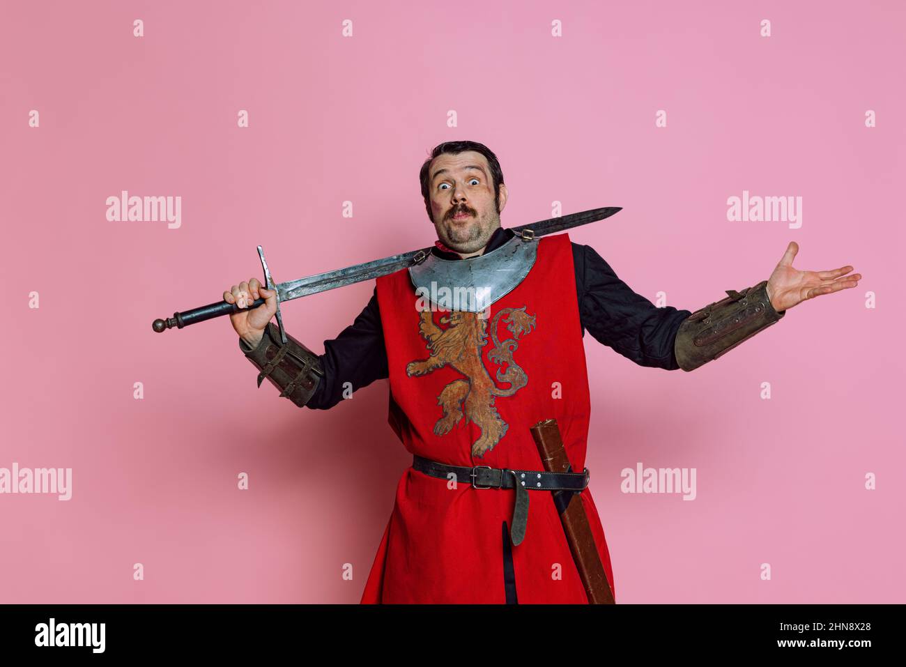 One young man, medieval warrior or knight wearing wearing armor ...