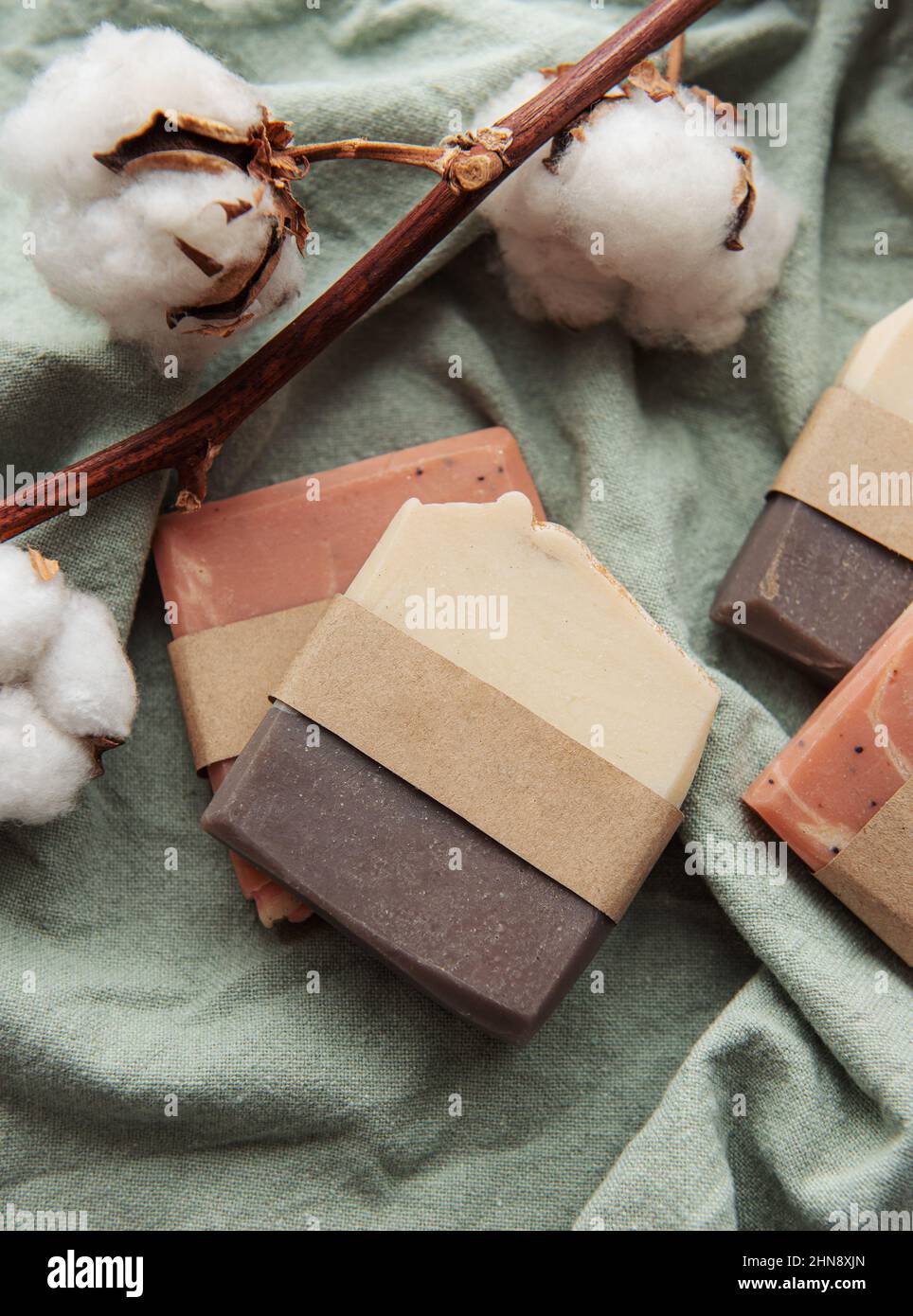 Handmade natural organic soap bars and cotton flowers on textile ...