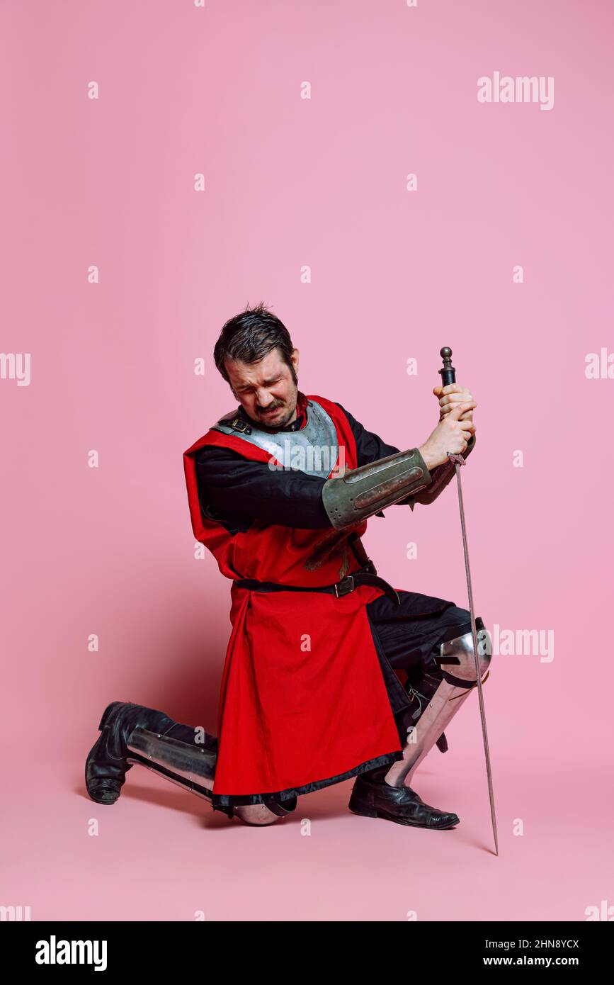 Crying young man, medieval warrior or knight wearing wearing armor ...