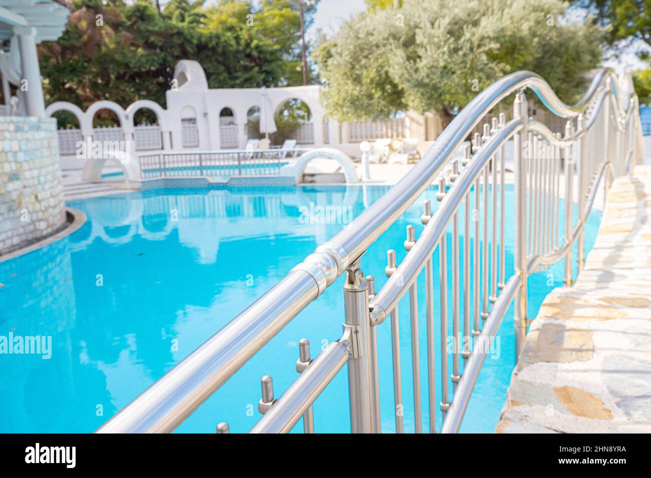 Decorative bridge over blue swimming pool in resort area Stock Photo ...