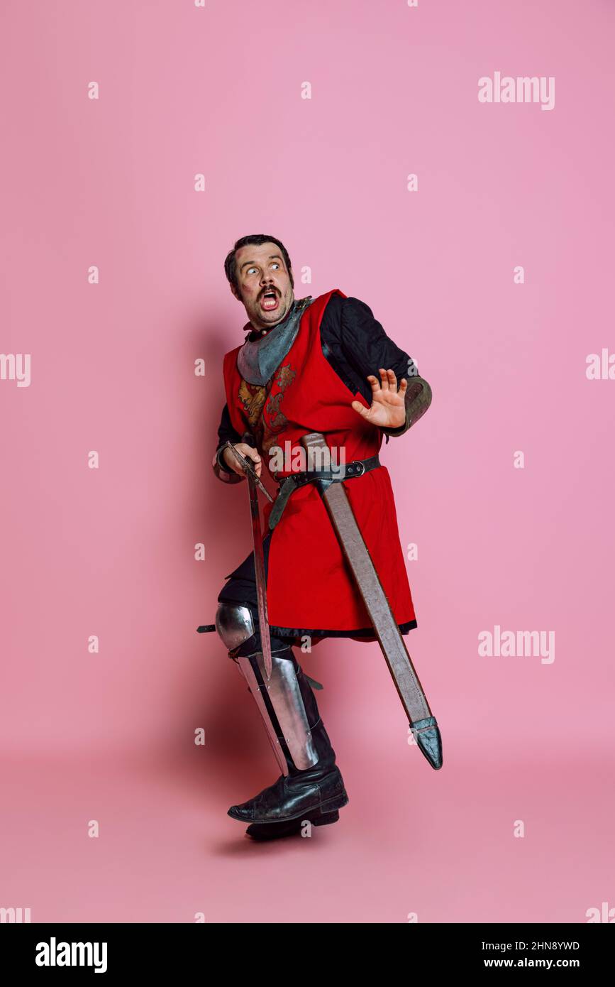 Full-length portrait of scary man, medieval warrior or knight in armor ...