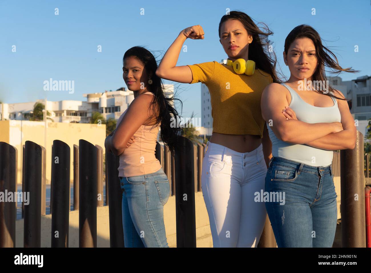 Three women are posing on the street city. Femininity Concept Stock ... Three women are posing on the street city. Femininity Concept Stock ...