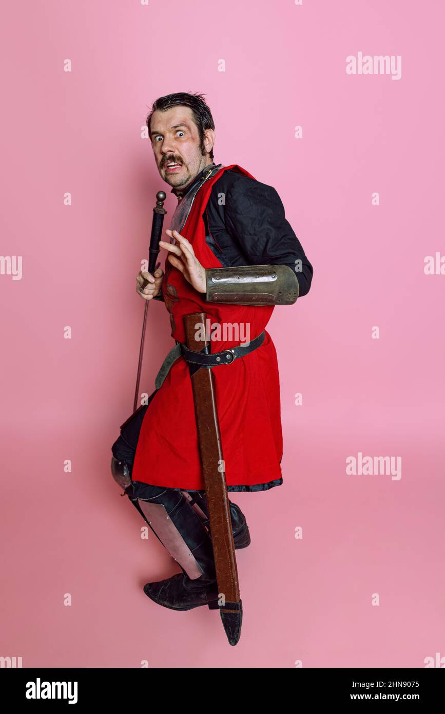 Full-length portrait of scary man, medieval warrior or knight in armor ...