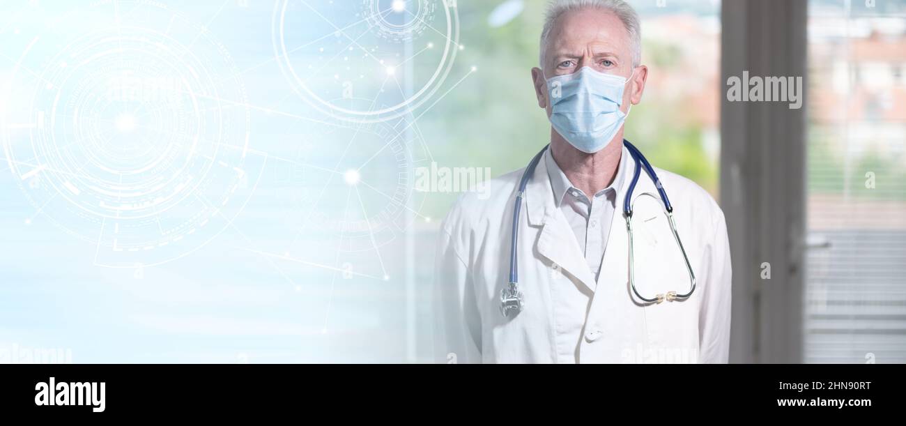 Portrait of senior doctor with arms crossed wearing a face mask ...