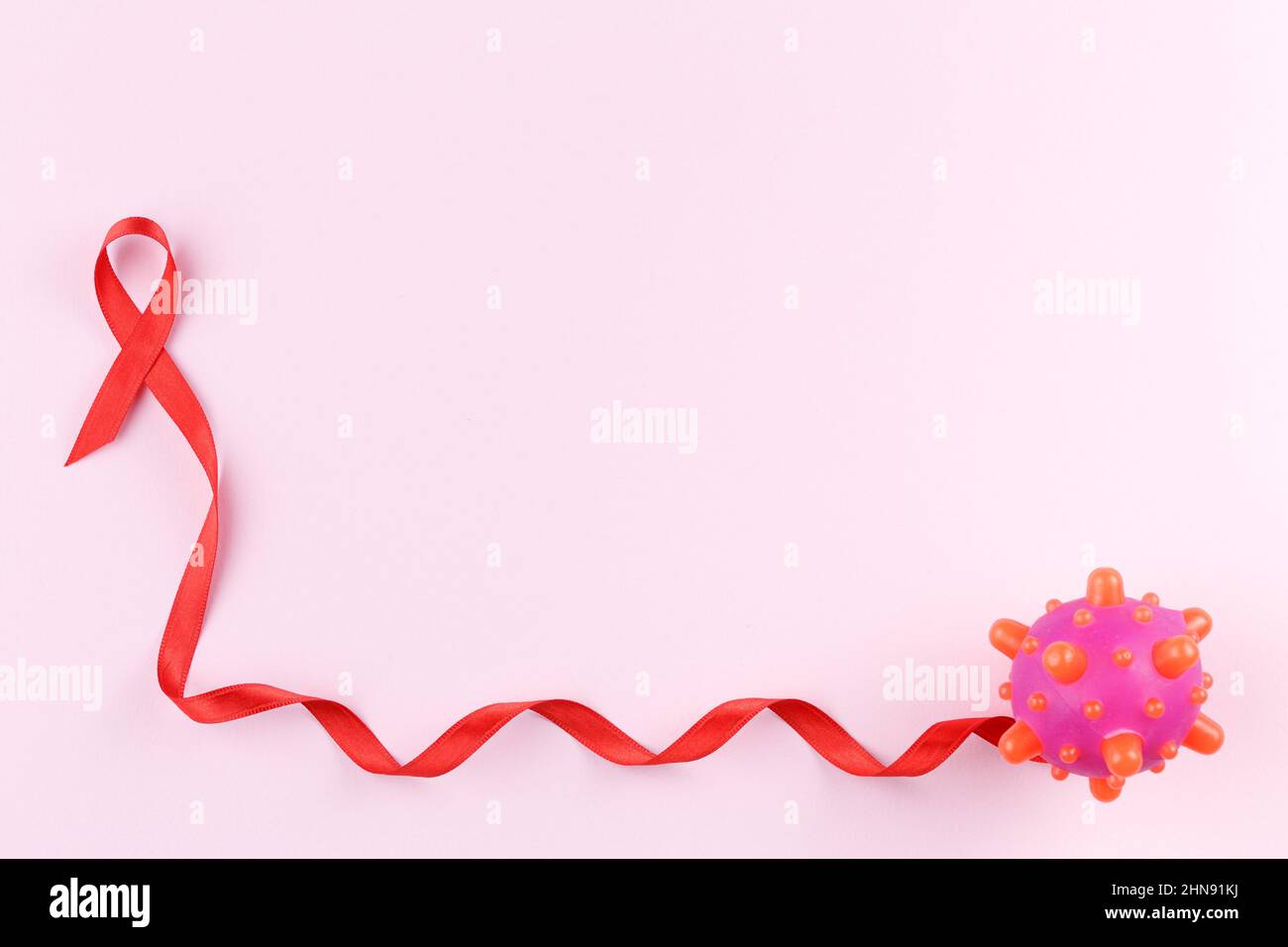 Red ribbon. Cancer control symbol Stock Photo - Alamy