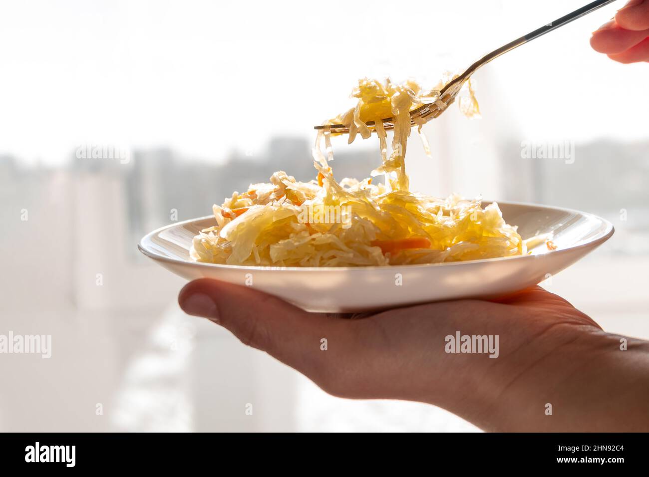 Sauerkraut with vegetable oil in rays of daylight. National european ...