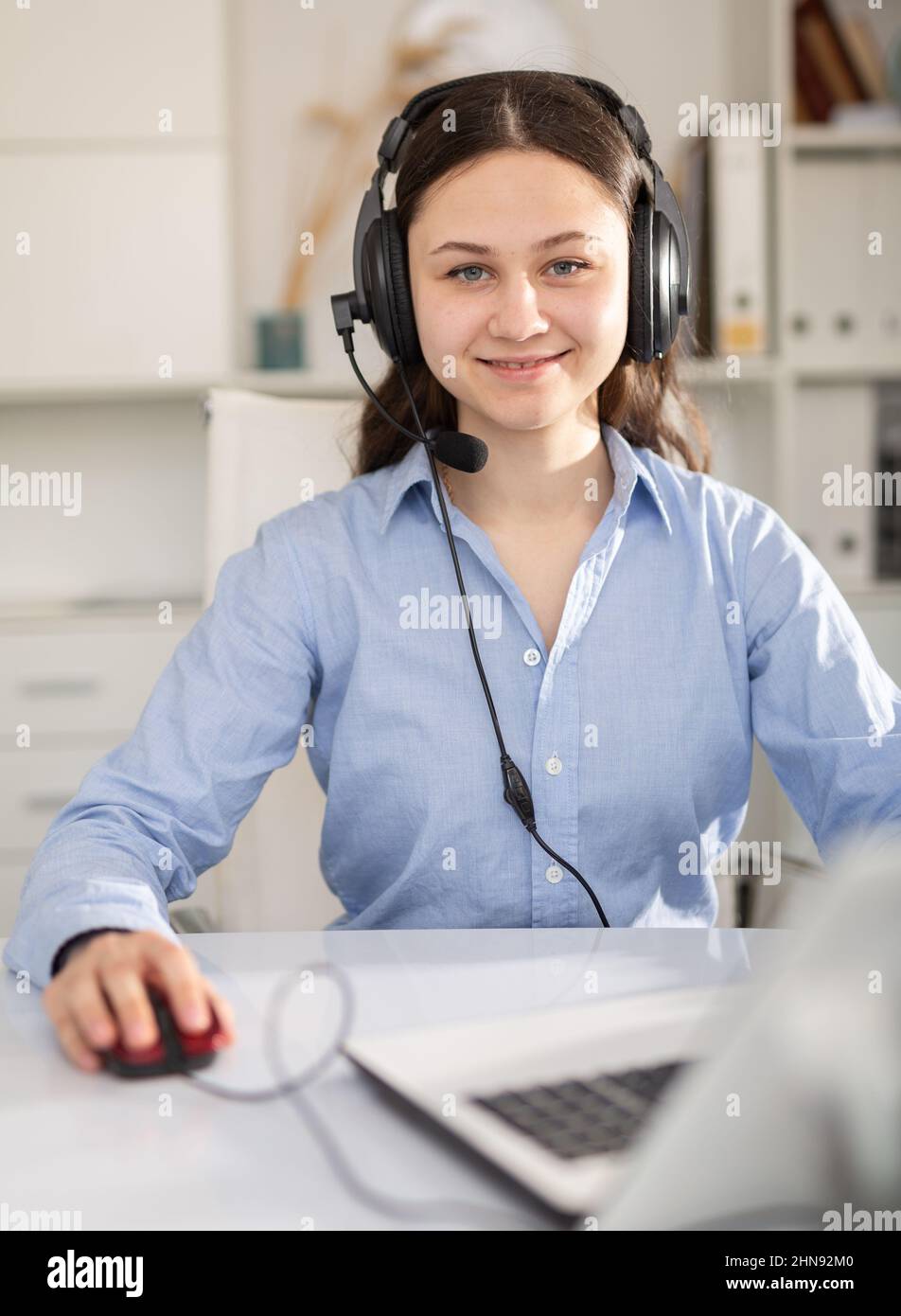 Positive dispatcher girl in the office sits at the workplace Stock ...