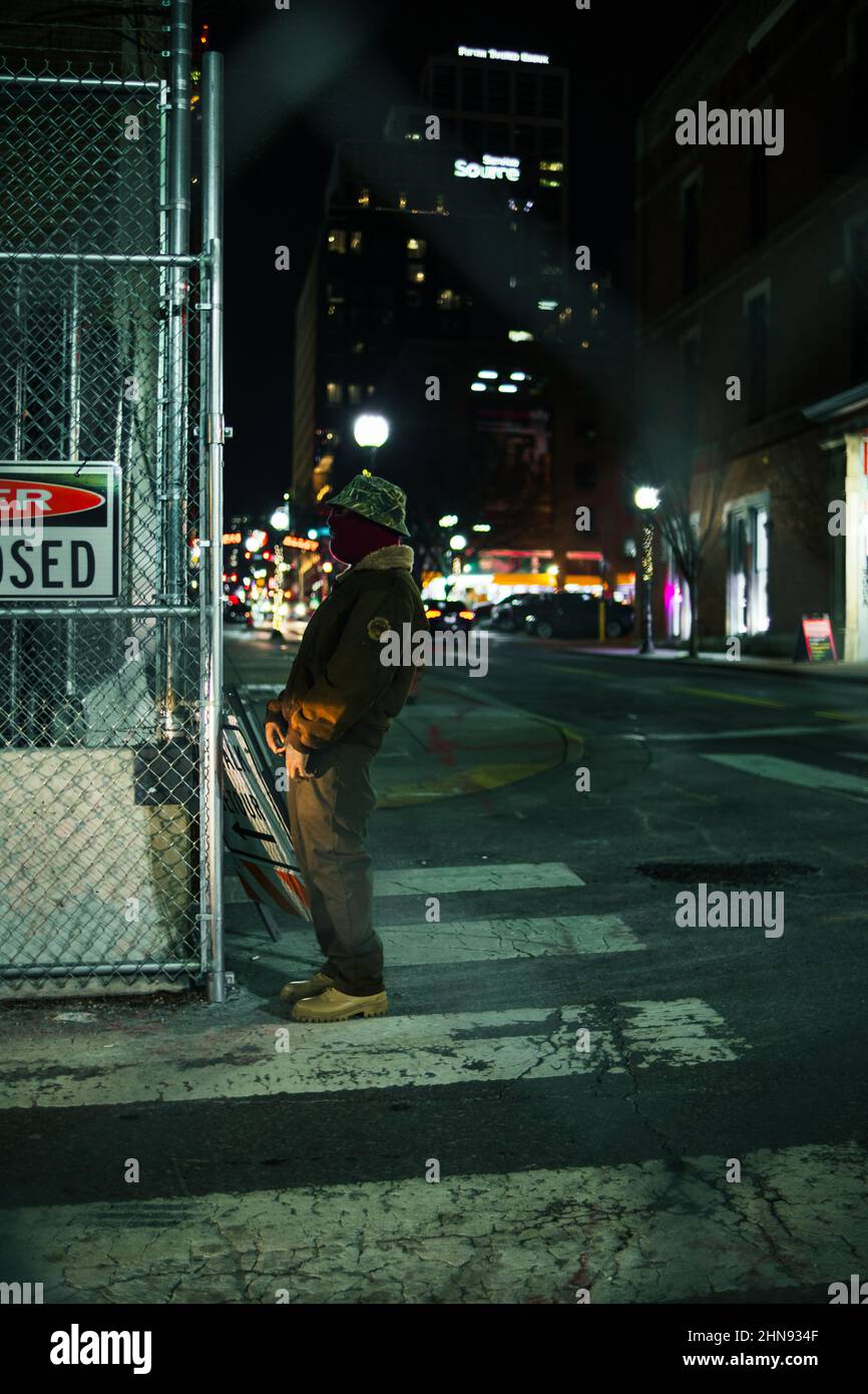 Male with a closed face outside at night Stock Photo - Alamy