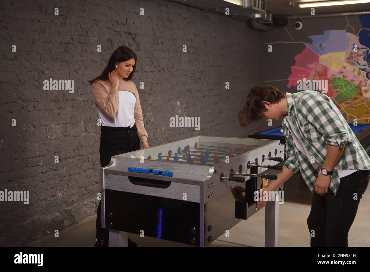 Young couple playing table soccer on a date Stock Photo - Alamy