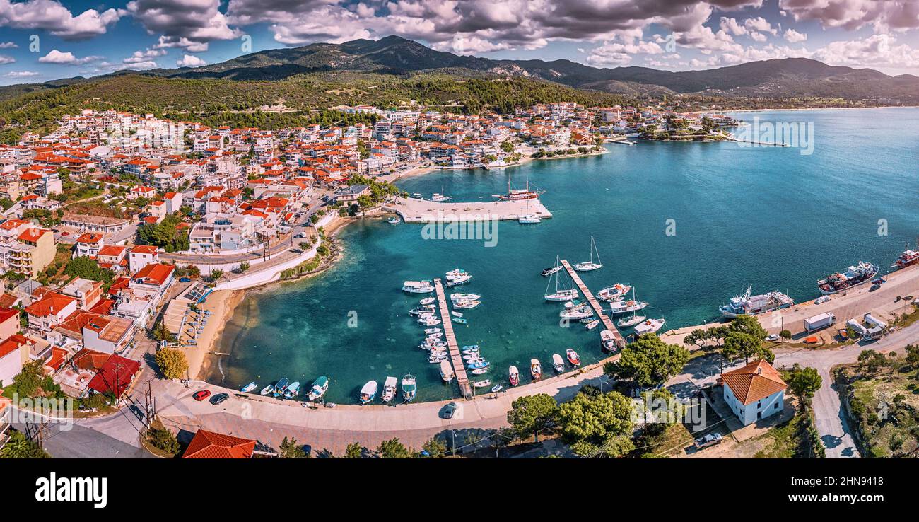 Aerial panorama of a scenic resort town Neos Marmaras with yacht marina ...