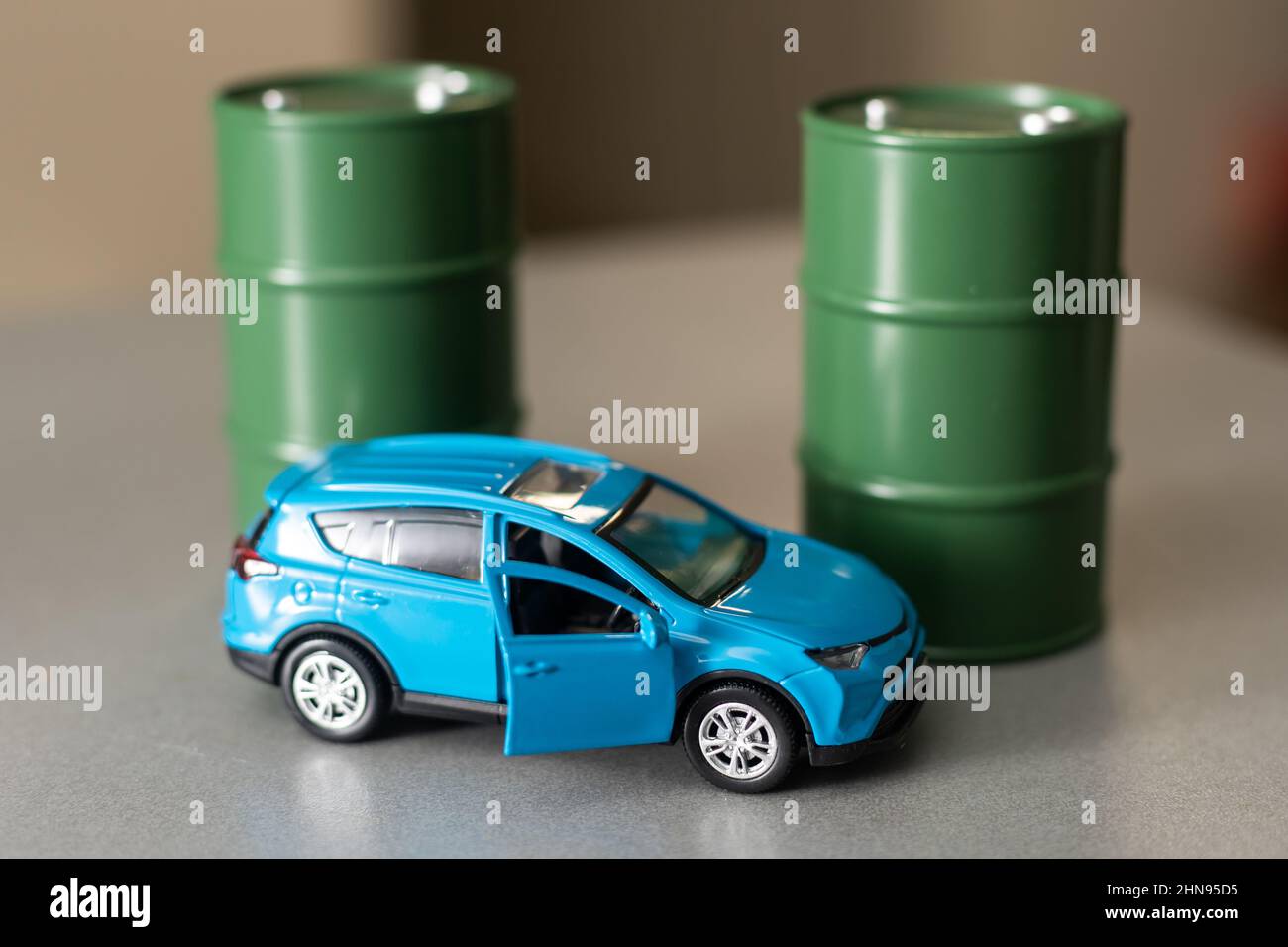 Toy car with toy oil barrel on white background Stock Photo - Alamy