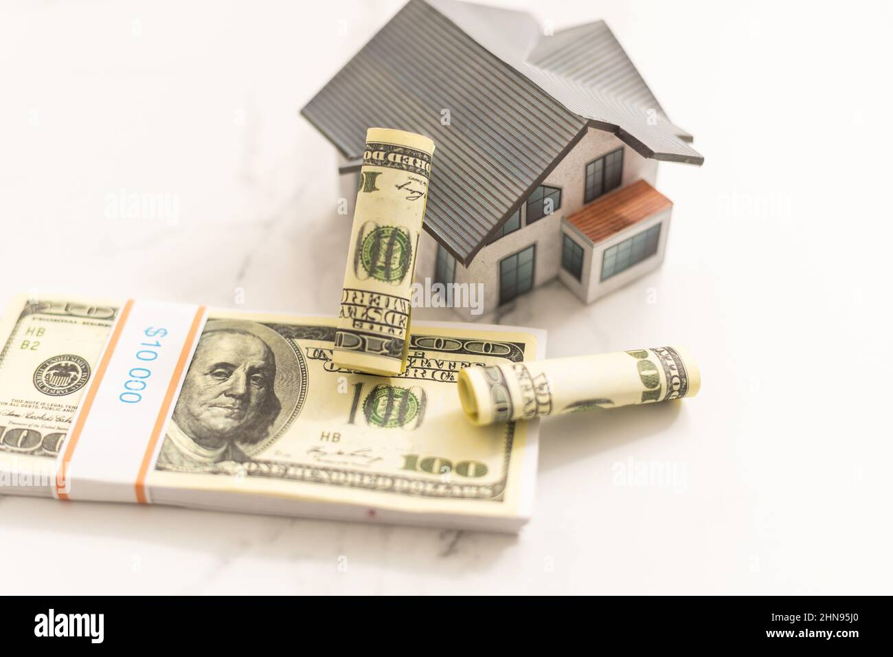 Miniature toy house and money Stock Photo - Alamy