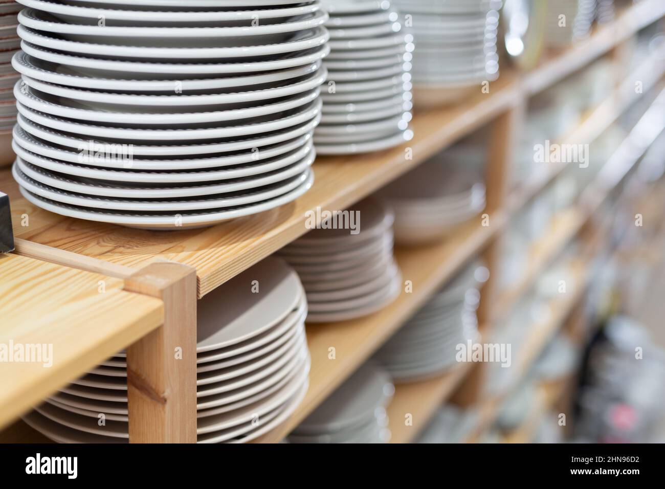 Plates displayed on shelving in household goods store Stock Photo - Alamy