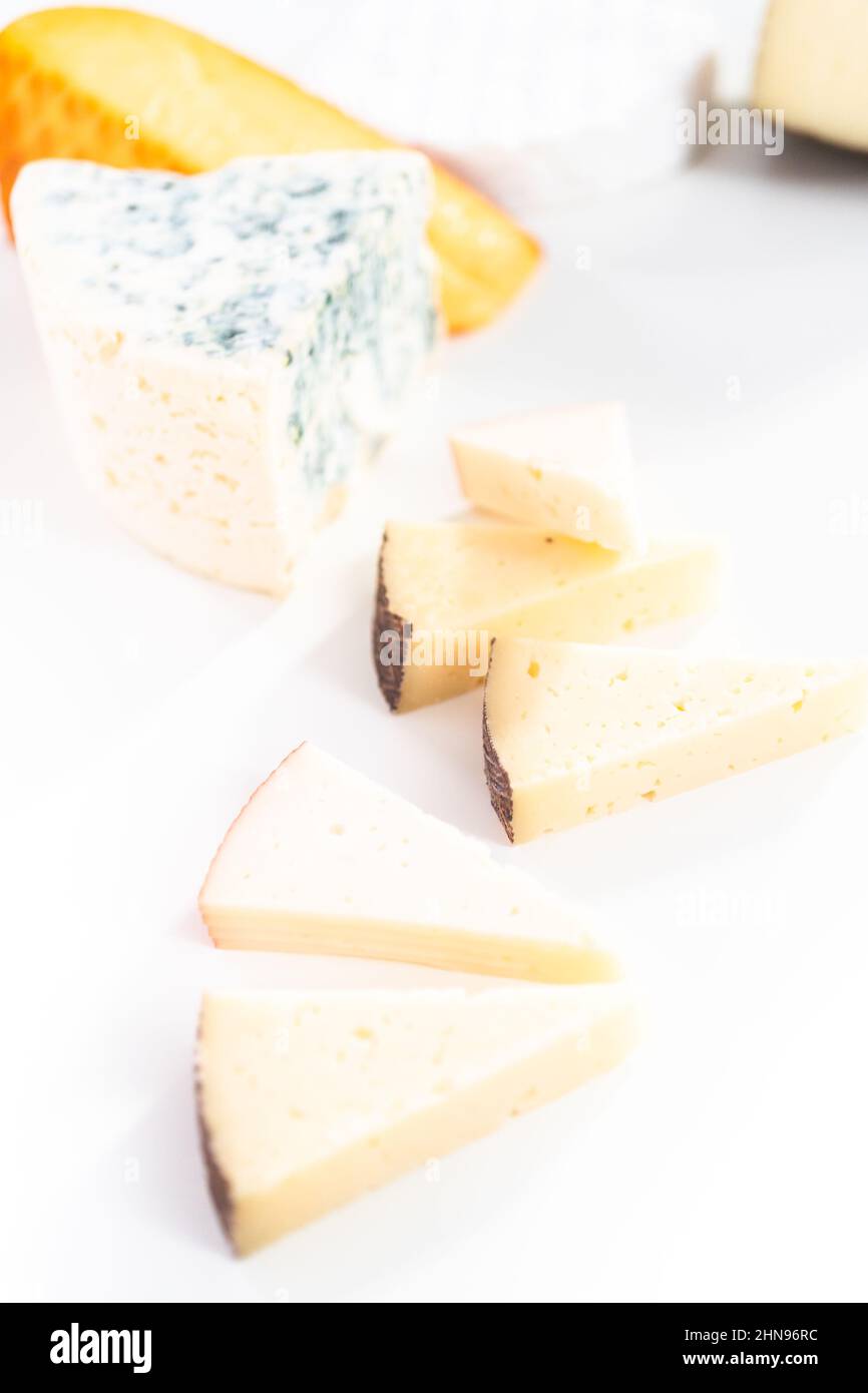 Variety of large wedges gourmet cheese on a white background Stock ...