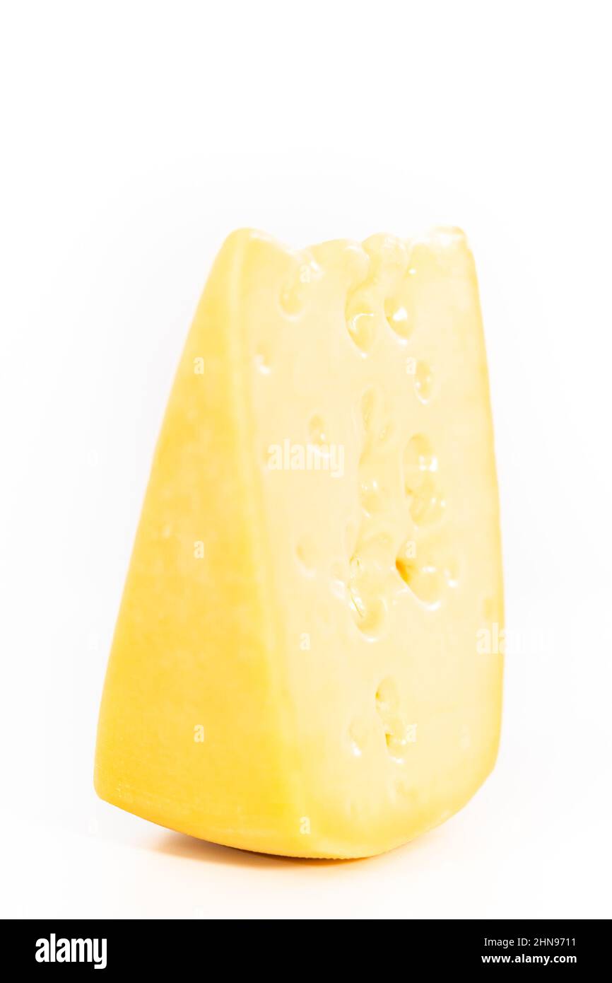 Large slice of semi soft part skim cheese on a white background Stock ...