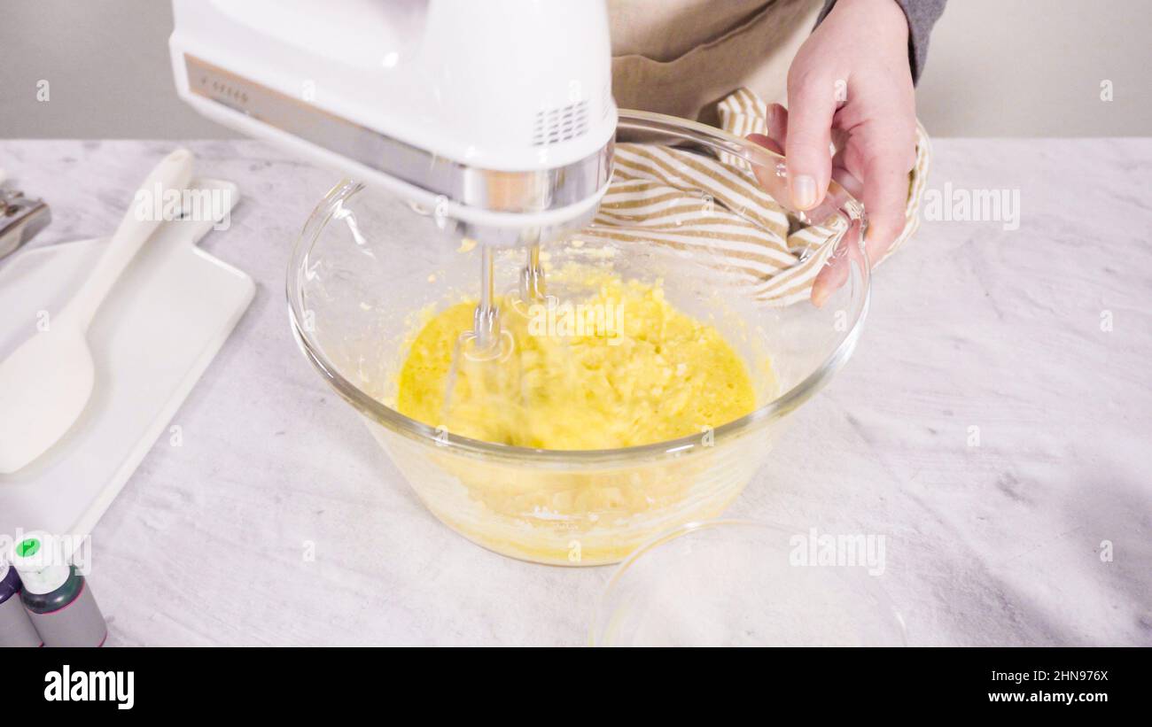 Step by step. Mixing ingredient in a mixing bowl with an electric mixer ...