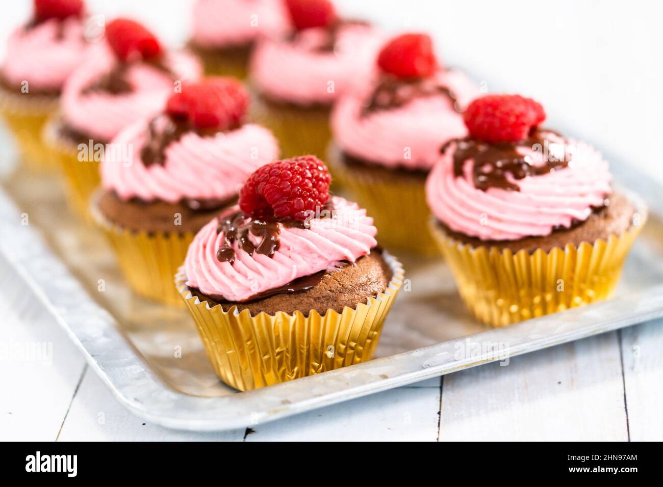 Gourmet chocolate raspberry cupcakes drizzled with chocolate ganache ...
