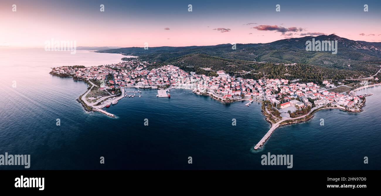 Wide aerial panoramic sunset view of a resort sea town Neos Marmaras in ...
