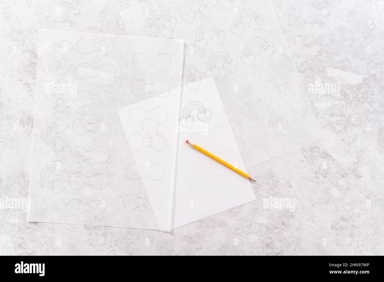 Flat lay. Drawing a template on parchment paper with a pencil for ...