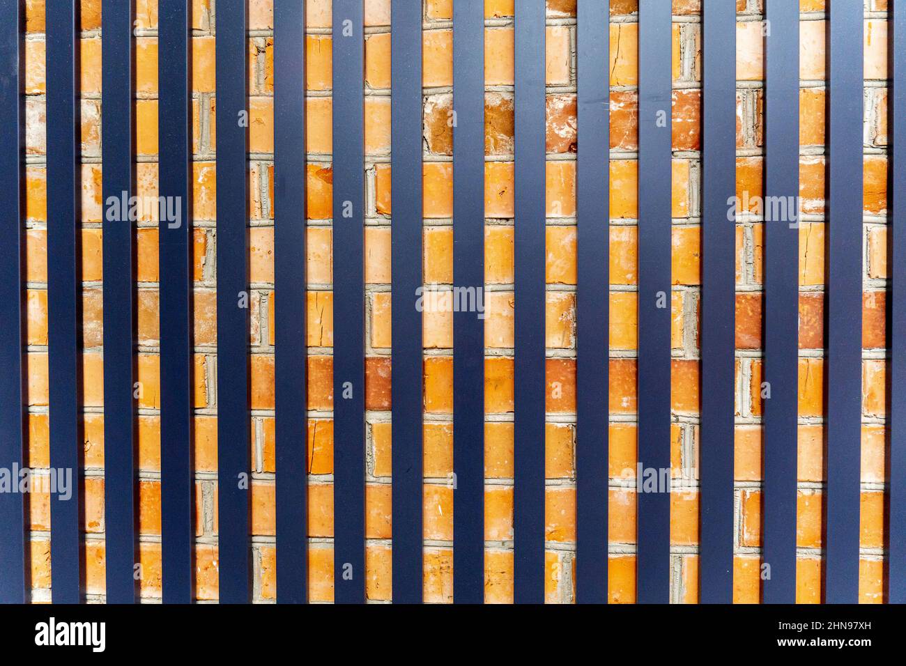 Iron sticks on a brick wall texture background Stock Photo - Alamy