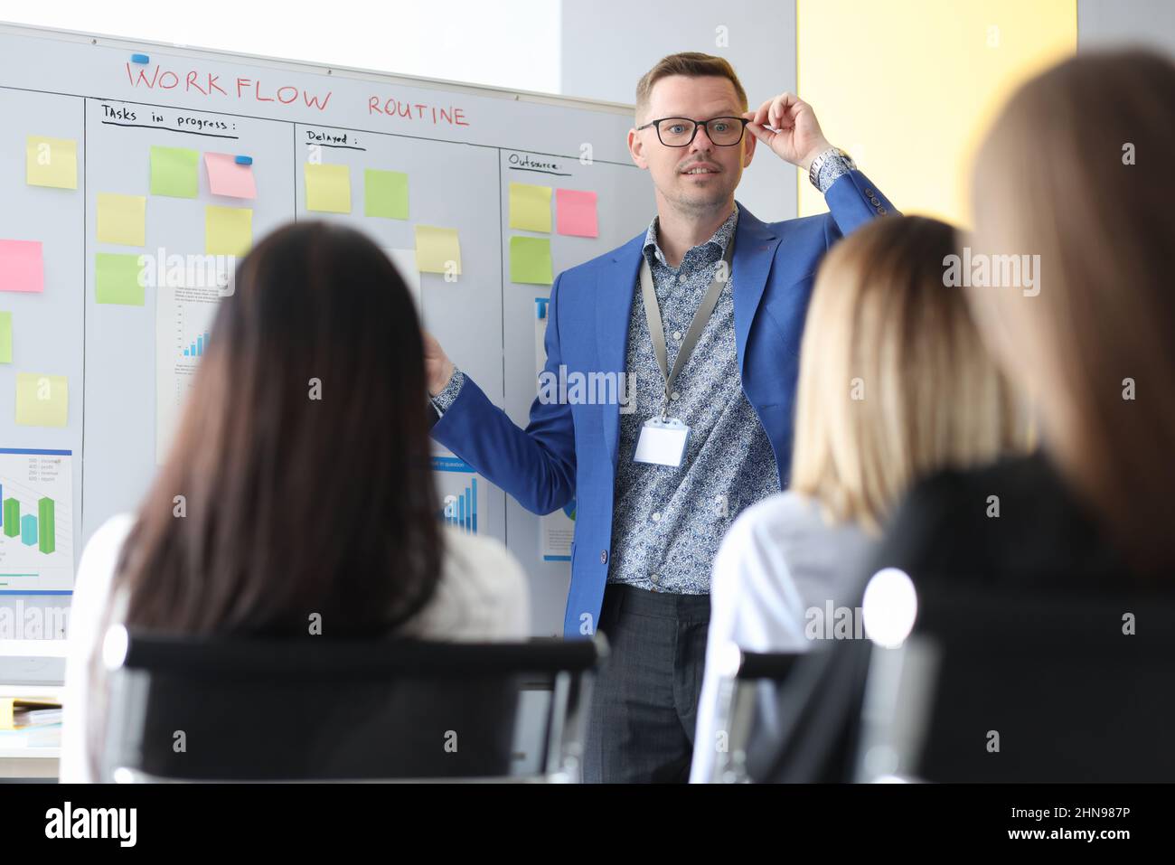 The coach in office standing at the blackboard teaches women Stock ...