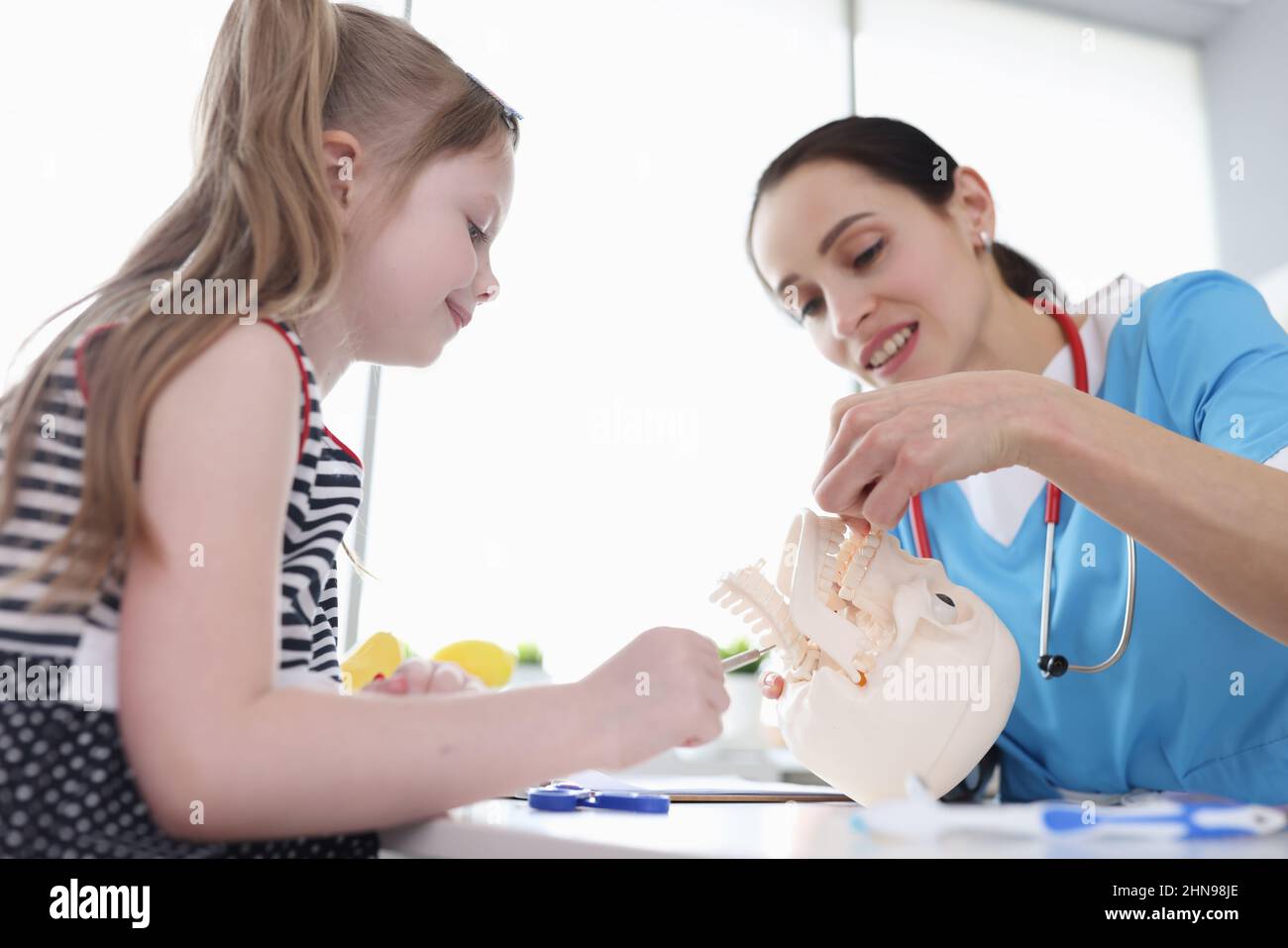 The doctor in the clinic teaches the child anatomy, close-up Stock ...