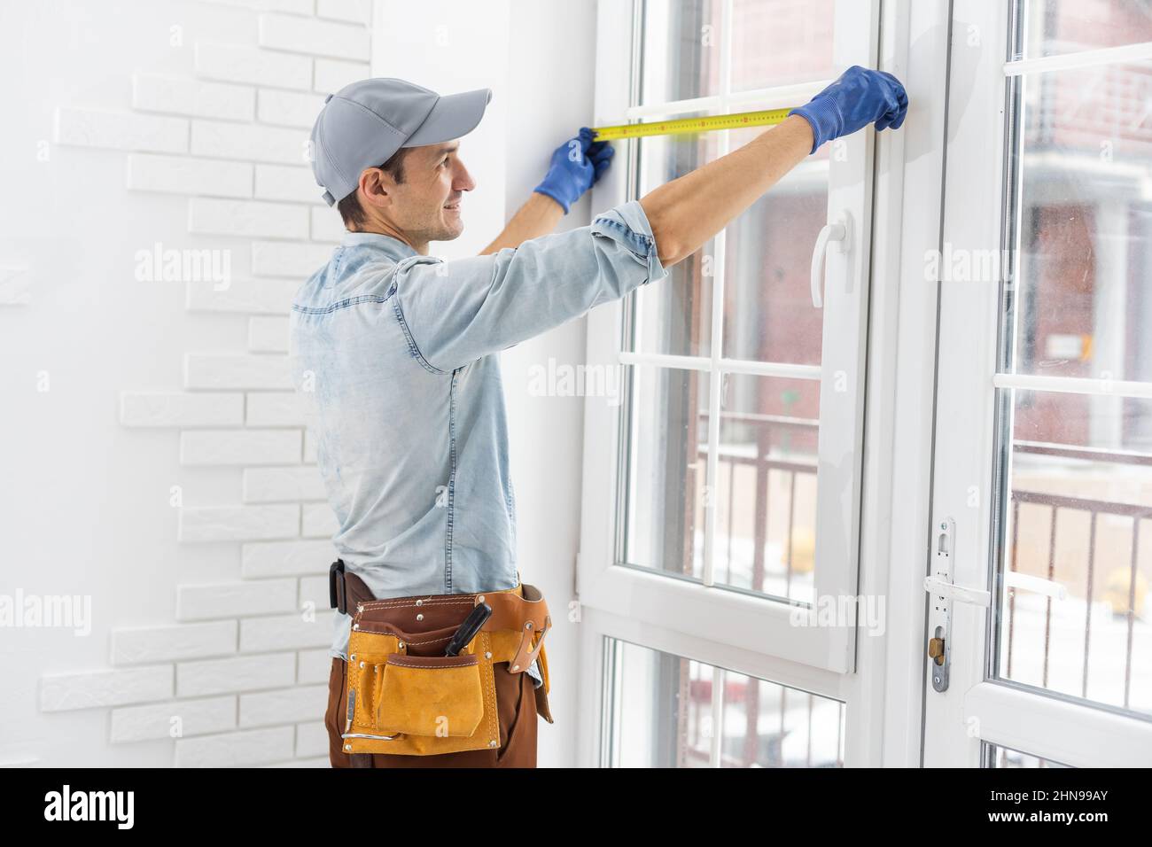 The worker installing and checking window in the house Stock Photo - Alamy
