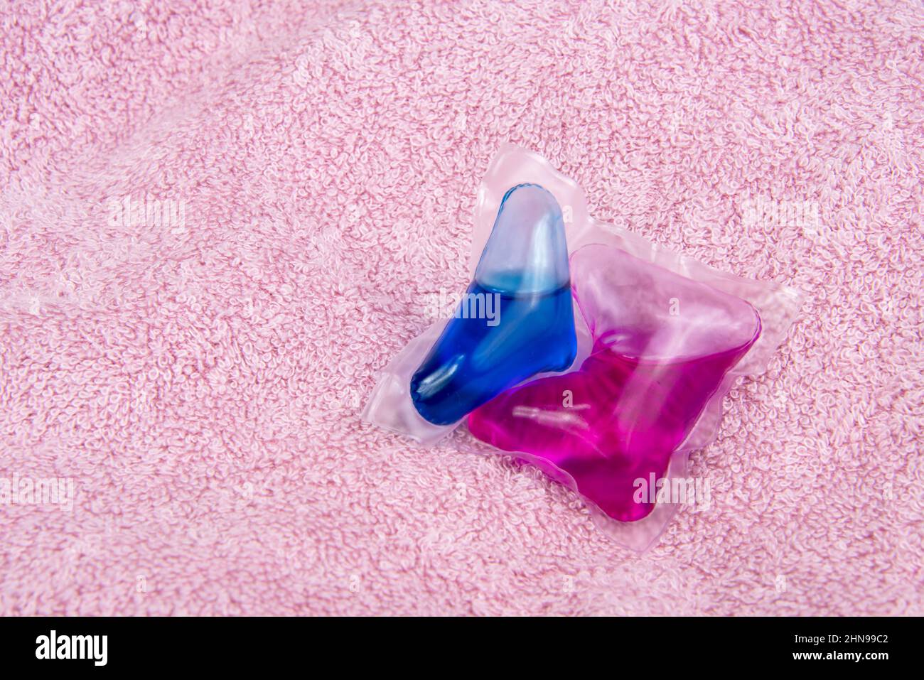 Colorful gel capsule for washing on pink material soft background Stock ...