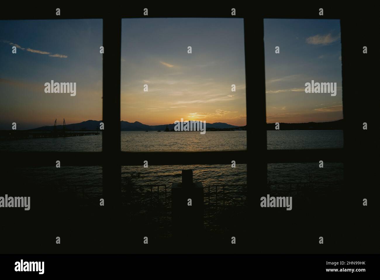 the sunset of subic bay through the window Stock Photo - Alamy