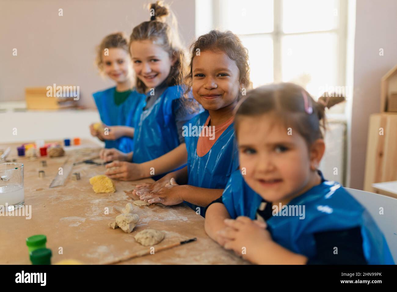 Group of little kids working with pottery clay during creative art and ...