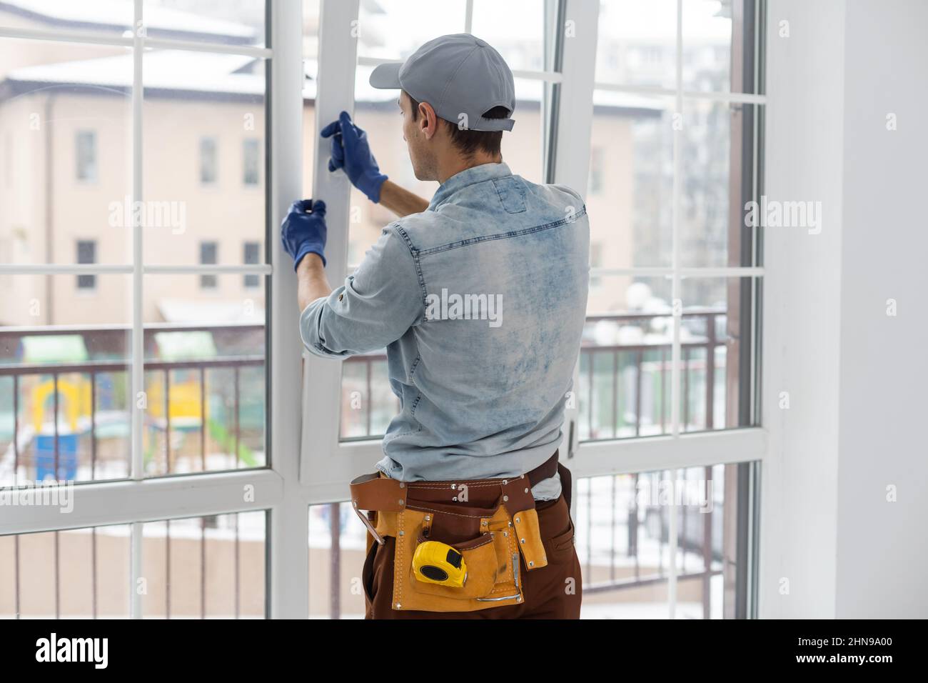 Construction worker installing window in house. Handyman fixing the ...