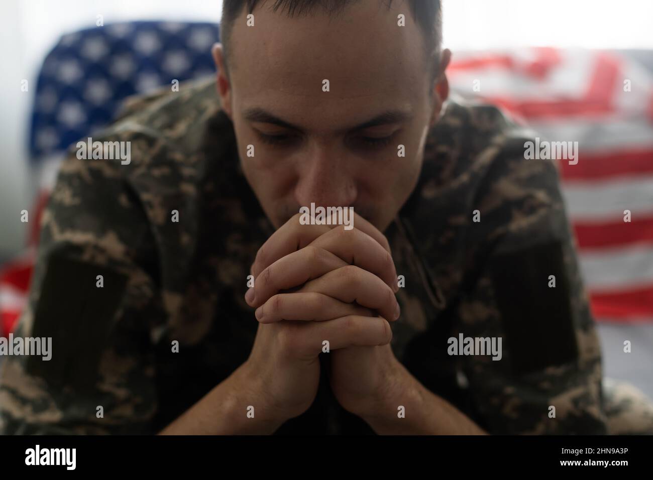 Sad man with USA flag at home. Memorial Day celebration Stock Photo - Alamy