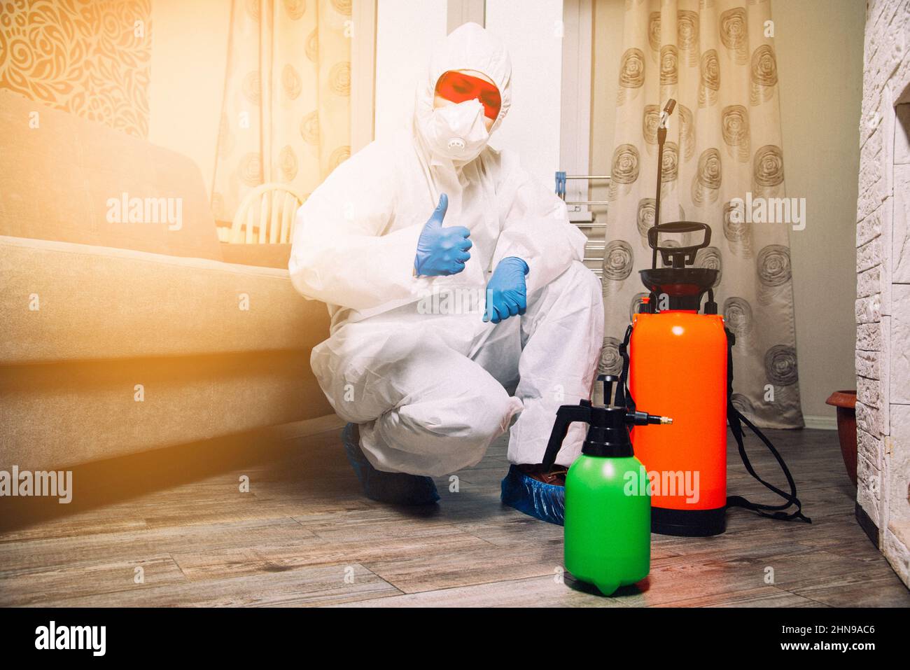 Exterminator in work clothes showing thumbs up. Fight against insects ...