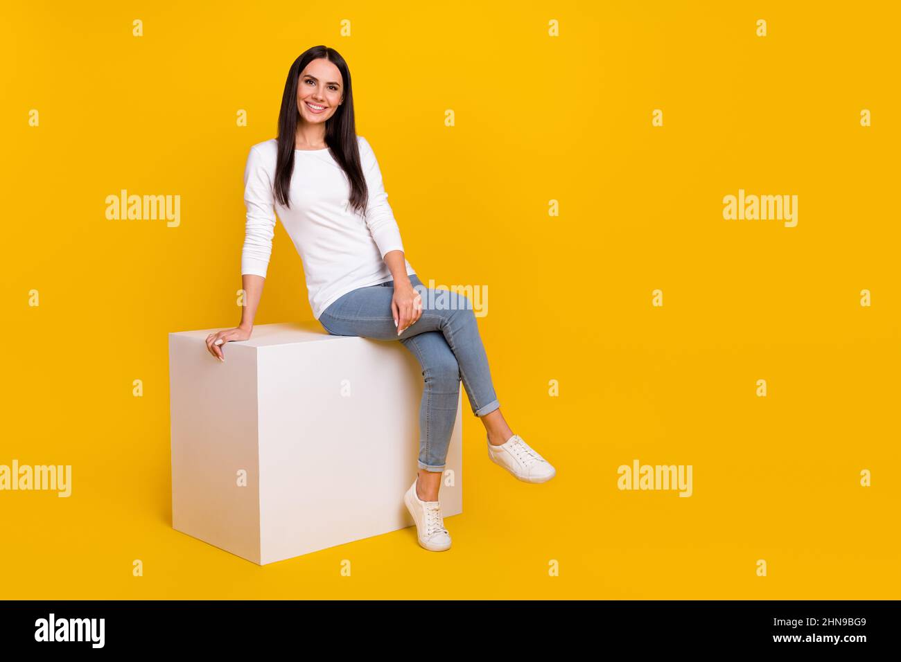 Full length photo of young cheerful adorable woman sit platform ads ...