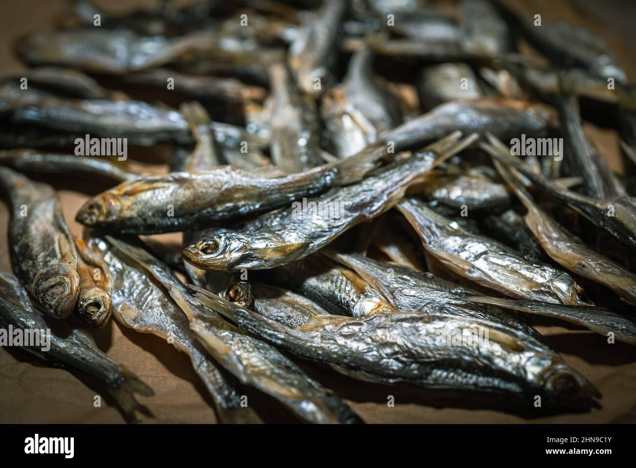 Lots of sun dried fish on the paper Stock Photo - Alamy