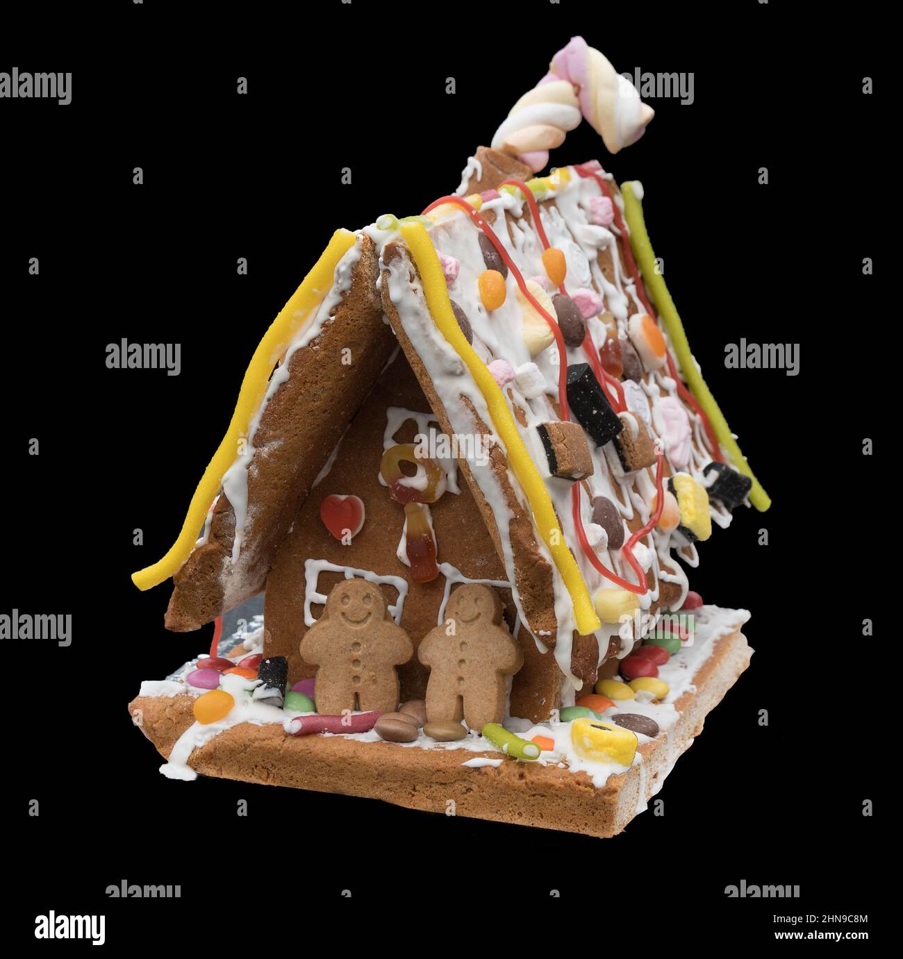 A Gingerbread house against a black background Stock Photo - Alamy