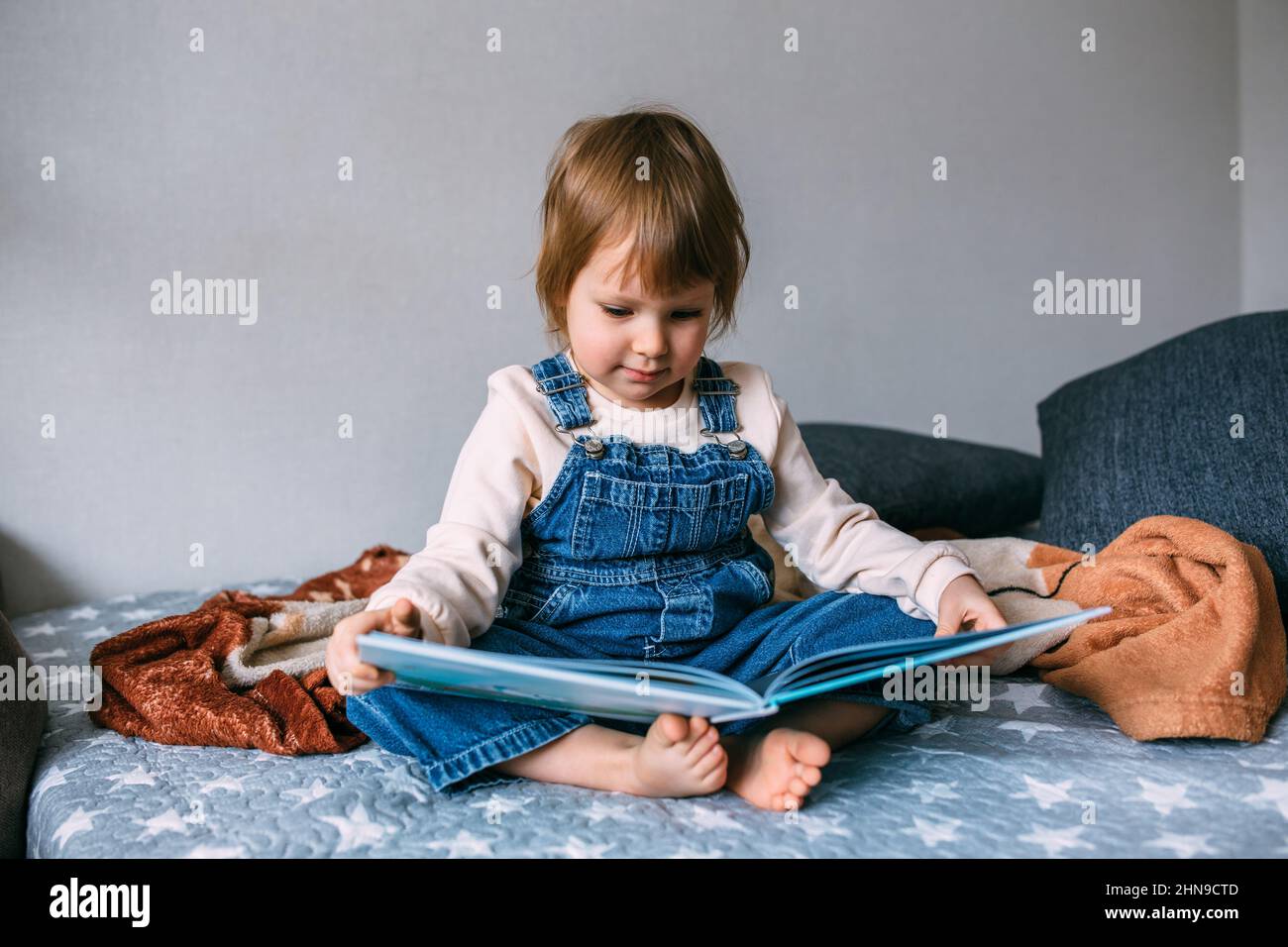 Kid reading fairy tales in bed hi-res stock photography and images - Alamy