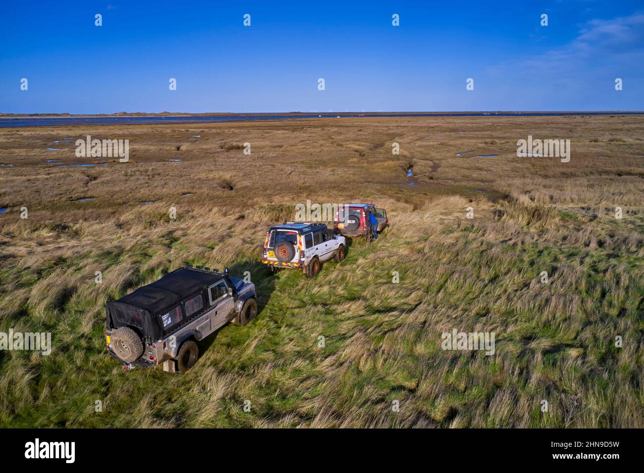 Land Rovers stop where the byway ends at the edge of the salt marshes ...
