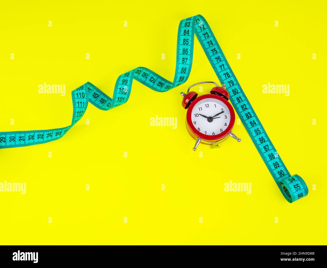 Pink tape measure on clock hi-res stock photography and images - Alamy