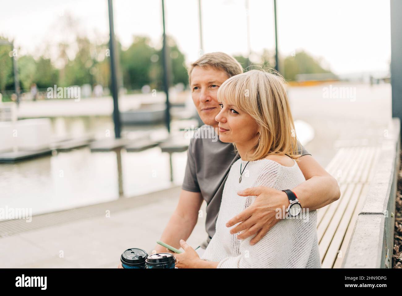 An Adult Mature Happy Couple In Love Sitting On Bench Outdoors In City