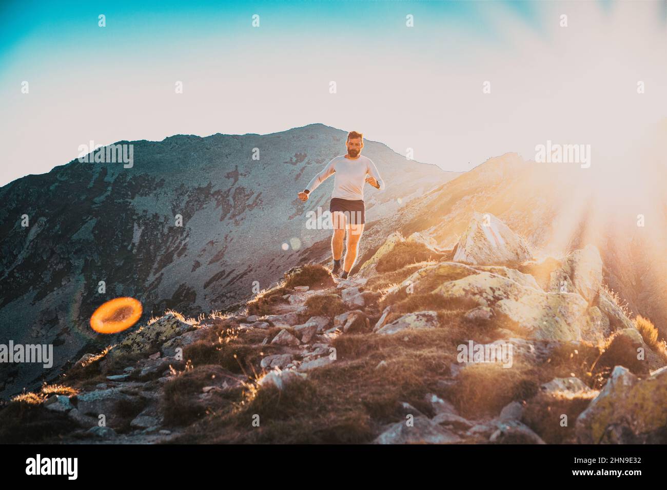 trail runner running in mountain landscape at sunset active lifestyle ...