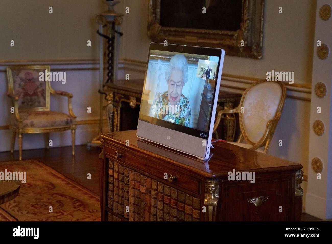 Queen Elizabeth II appears on a screen via videolink from Windsor ...