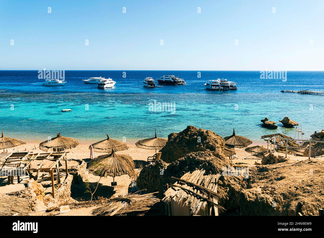 Sunny resort beach at the coast shore of Red Sea in Sharm el Sheikh ...