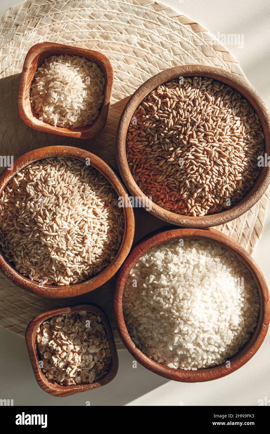 Set of different types of rice and cereals in wooden bowls Stock Photo ...