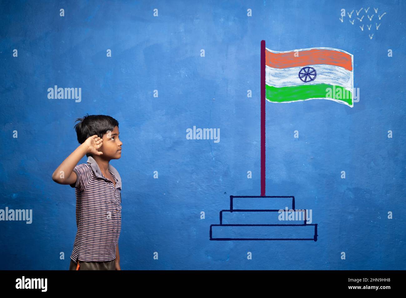 Little kid saluting be seeing indian flag on wall - concept of ...
